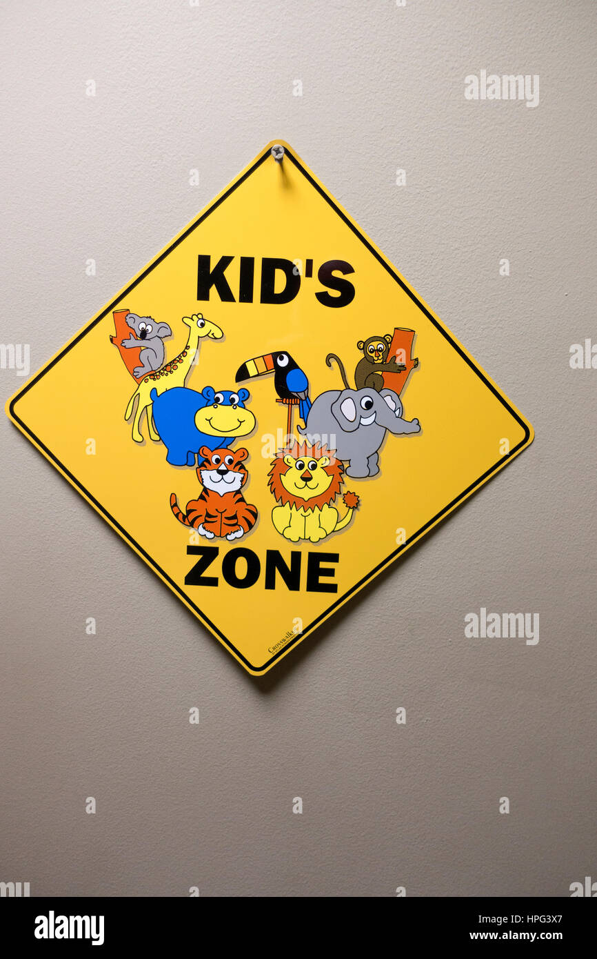 Yellow warning sign designating this area as a "Kid's Zone Stock Photo ...