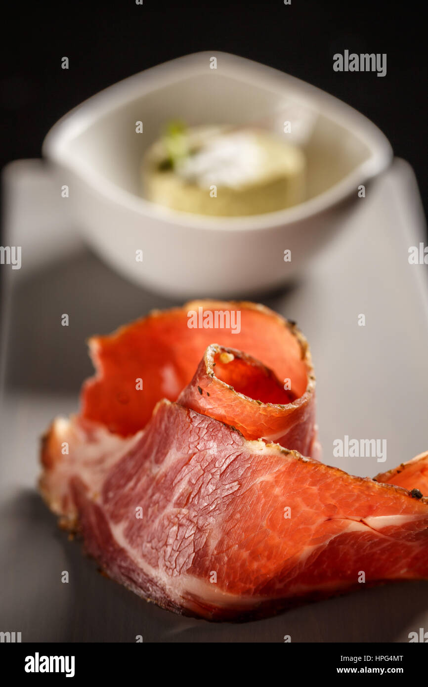Close up of prosciutto on fine dining appetizer plate Stock Photo - Alamy