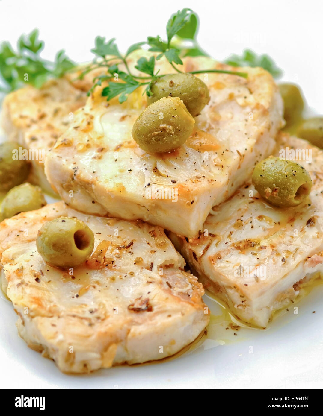 Cod fish with green olives Stock Photo - Alamy
