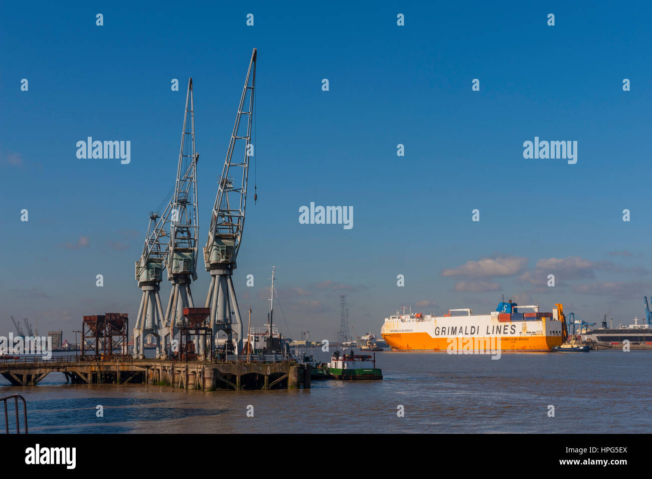 Car transporter boat at Tilbury docks with the cranes at Gravesend in ...