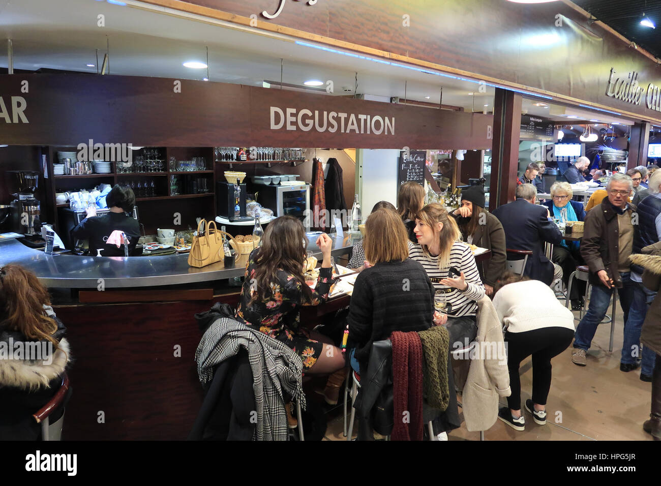 Many people eating at a restaurant at Les Halles de Lyon Stock Photo ...