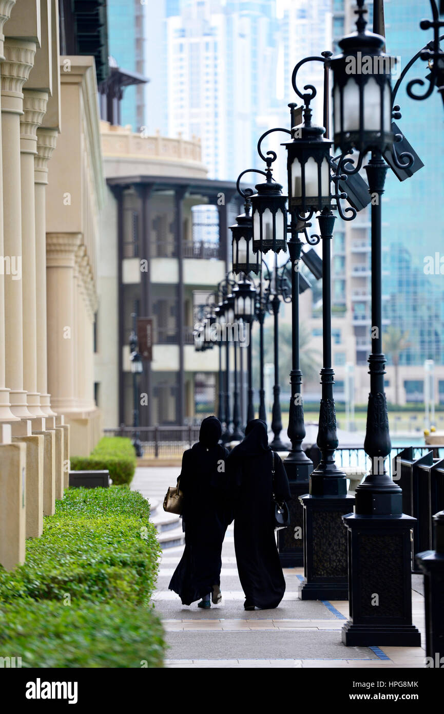United Arab Emirates, Dubai, veiled women from the back walking in the ...