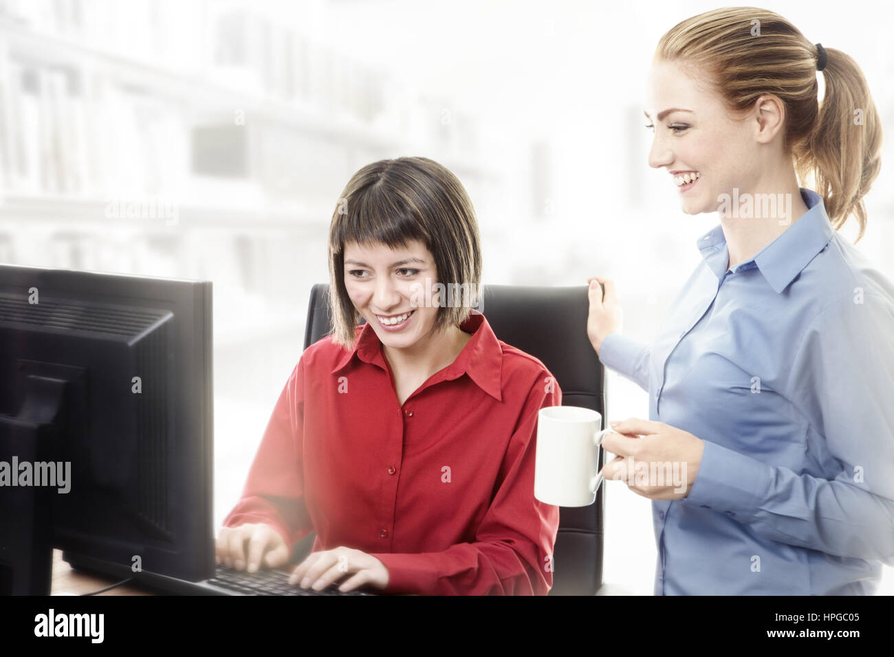 two work colleagues working together in the office Stock Photo - Alamy