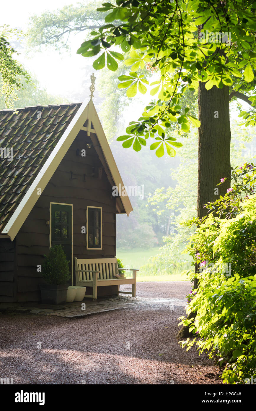 small house in a park in spring time Stock Photo - Alamy