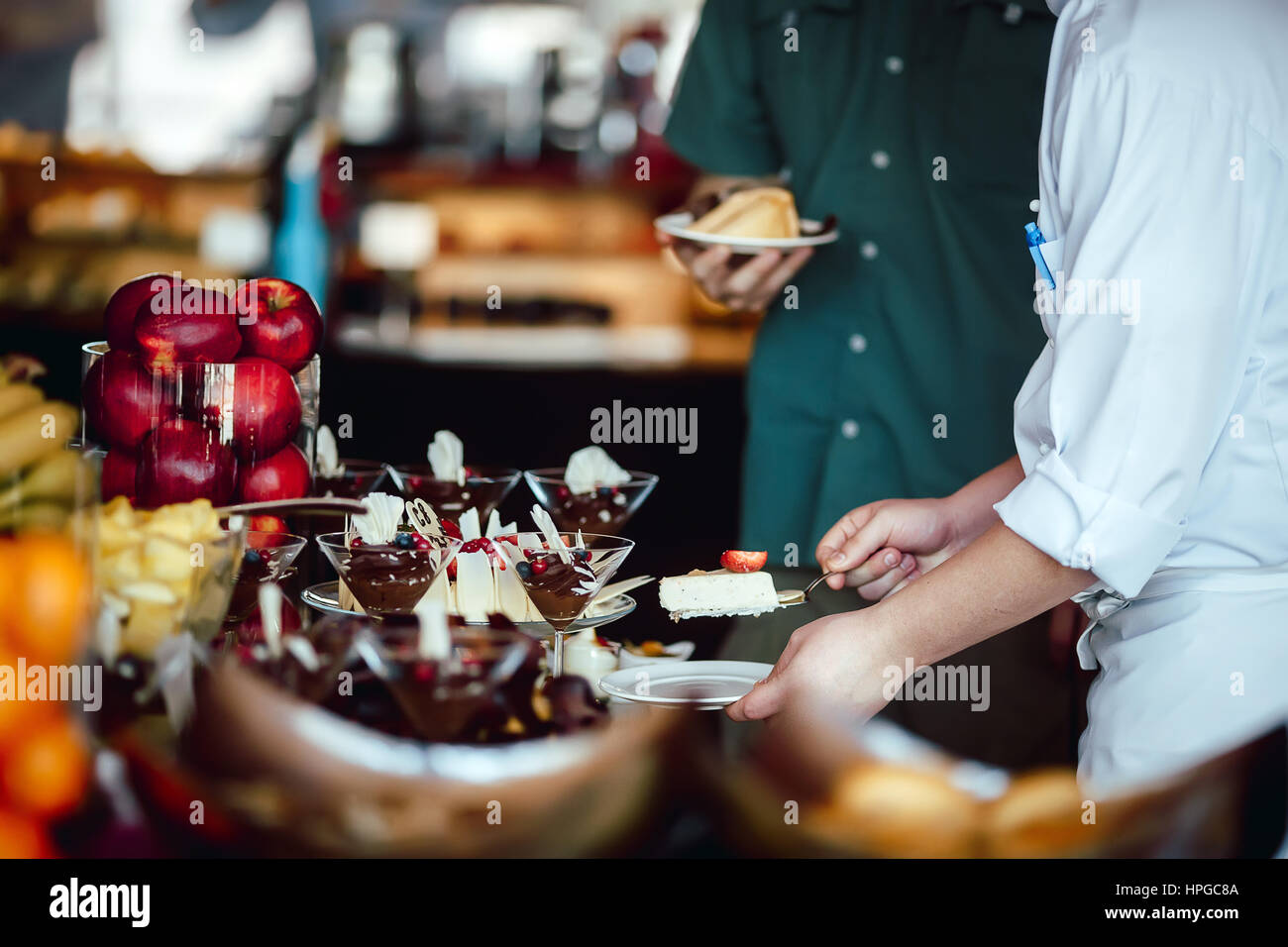 Chef treats guest cheesecake buffet closeup hands Stock Photo - Alamy