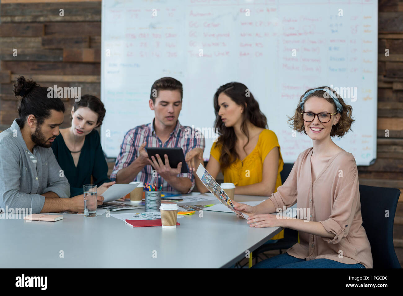 Graphic designers working together in office Stock Photo - Alamy