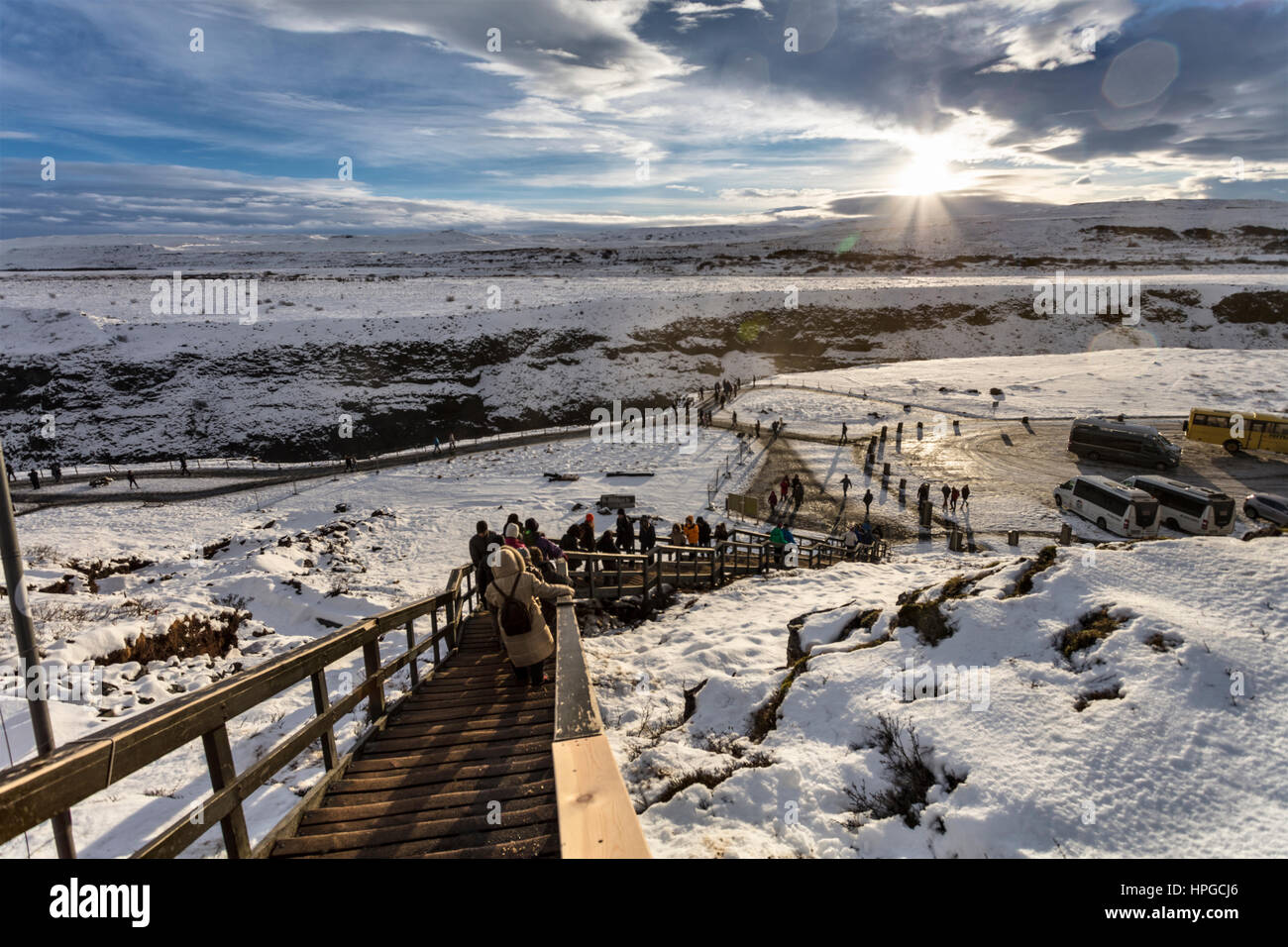 Tourists negotiate a staircase in the winter at Selfoss Waterfall in ...
