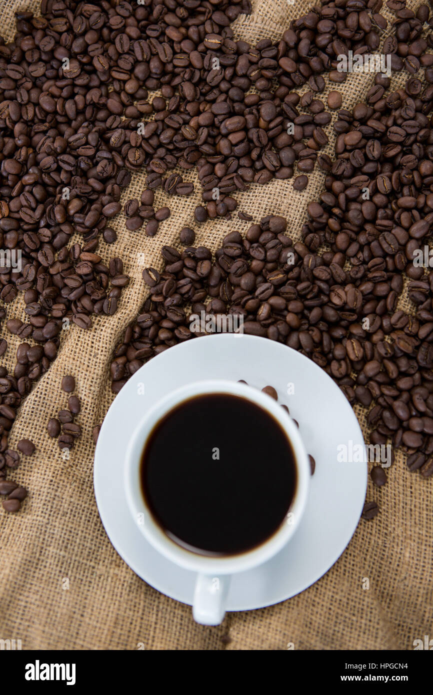 Black coffee and coffee beans on sack textile Stock Photo - Alamy