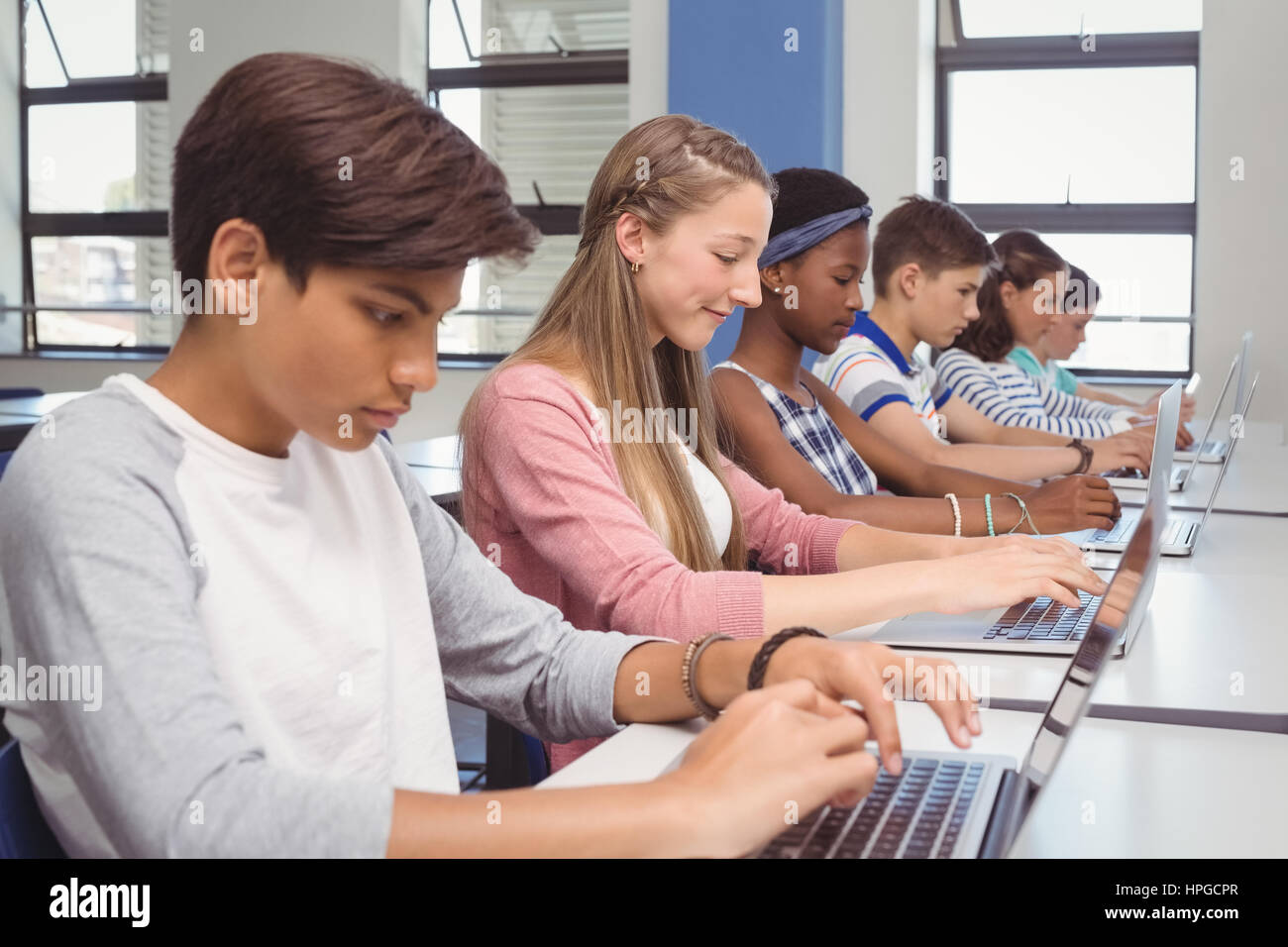 Students using laptop in classroom at school Stock Photo - Alamy