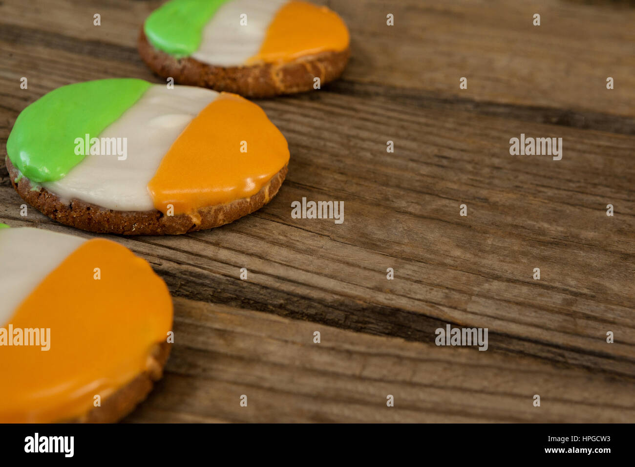 St. Patricks Day three cookies with irish flag toppings on wooden ...
