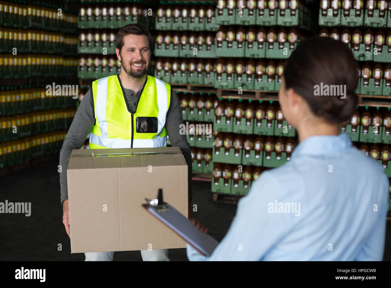 Factory workers interacting with each other in factory Stock Photo - Alamy