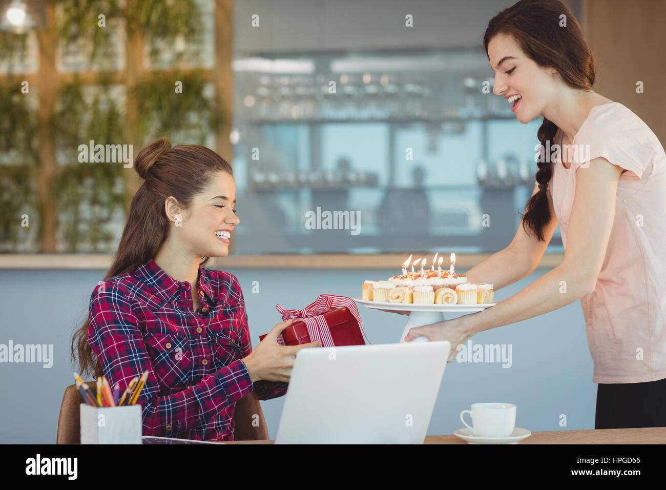 Executive celebrating her colleagues birthday in office Stock Photo - Alamy