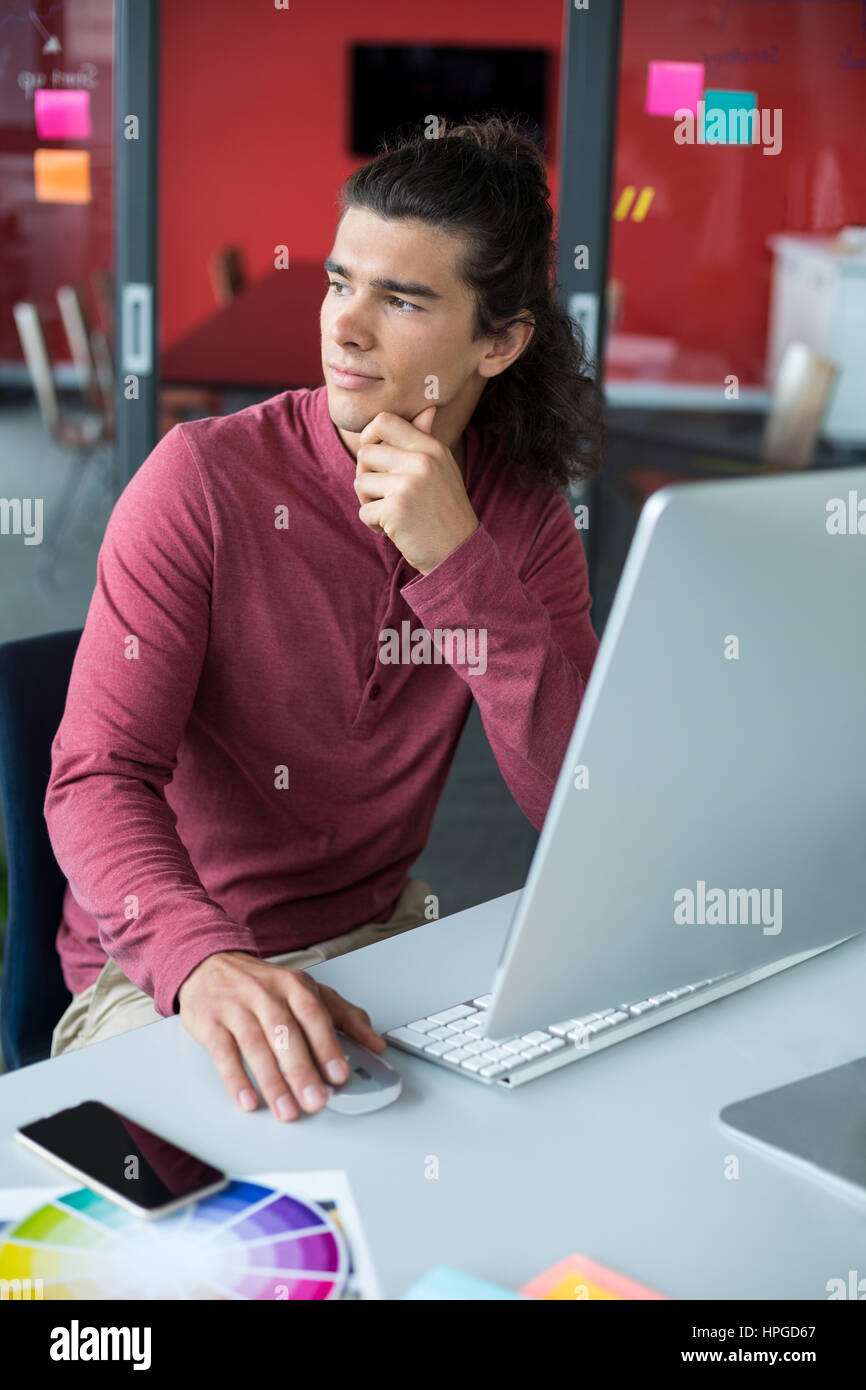 Thoughtful male executive working on personal computer in office Stock ...