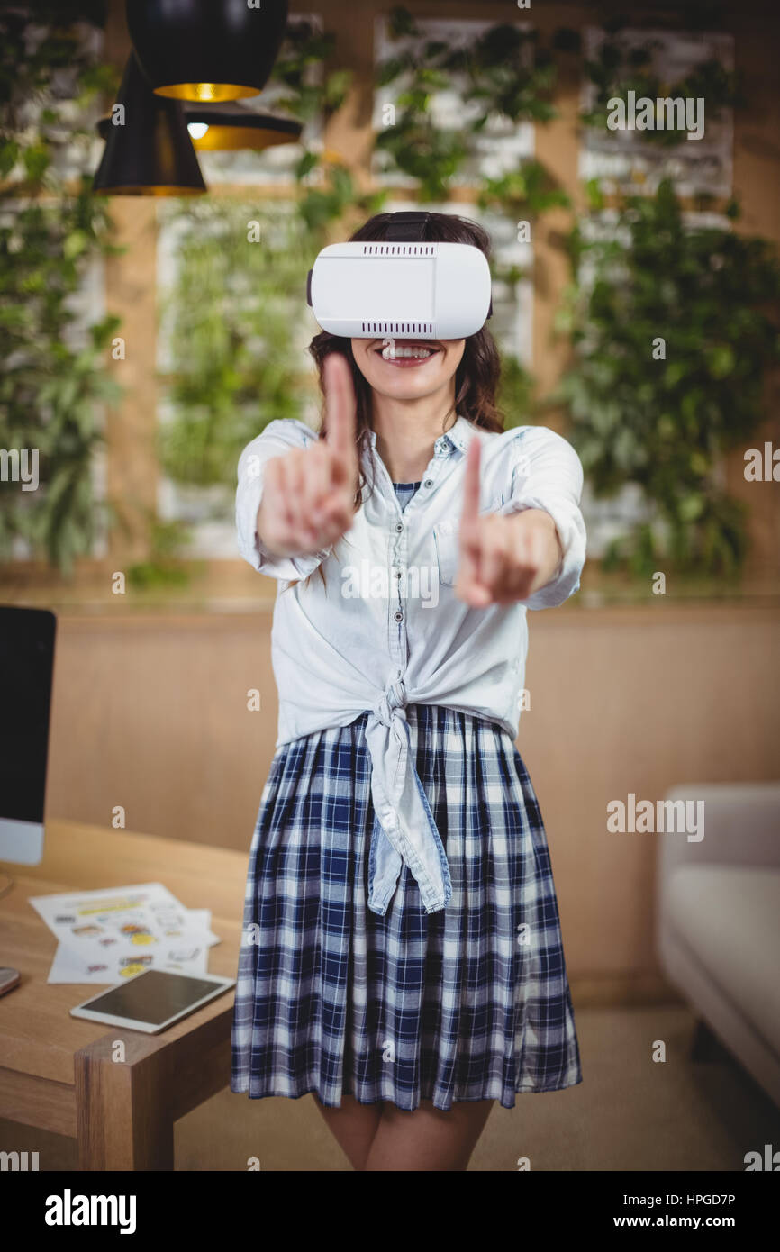 Female business executive using virtual reality headset in office Stock ...