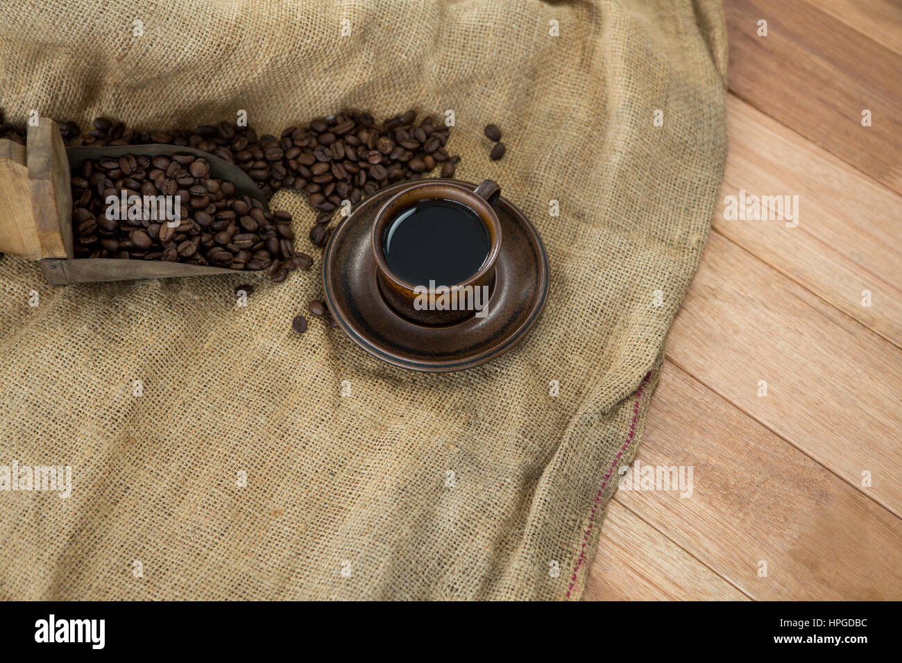 Black coffee with scoop and sack textile on wooden table Stock Photo ...
