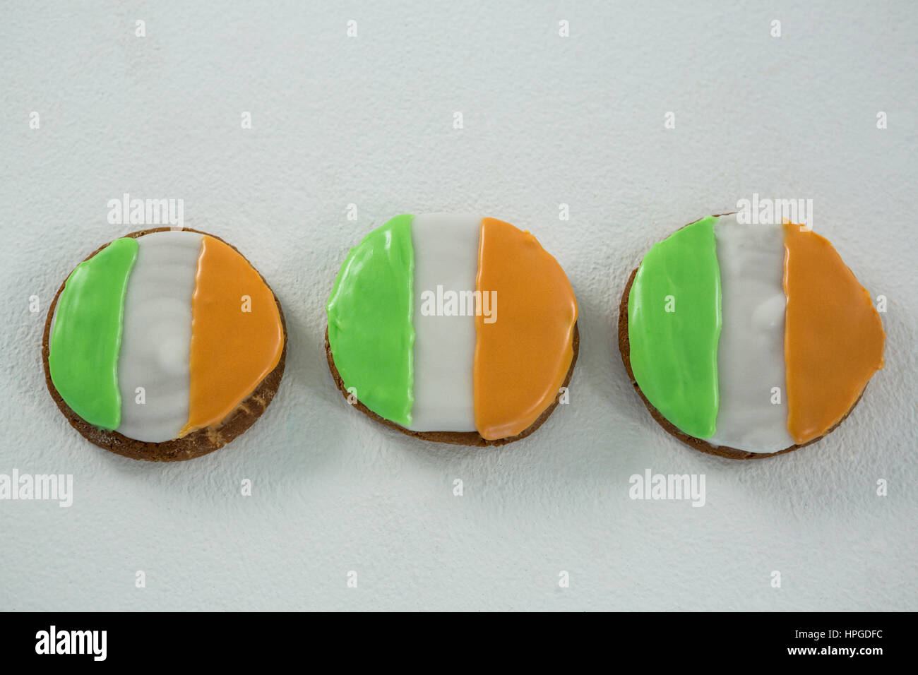 St. Patricks Day three cookies with irish flag toppings on white ...