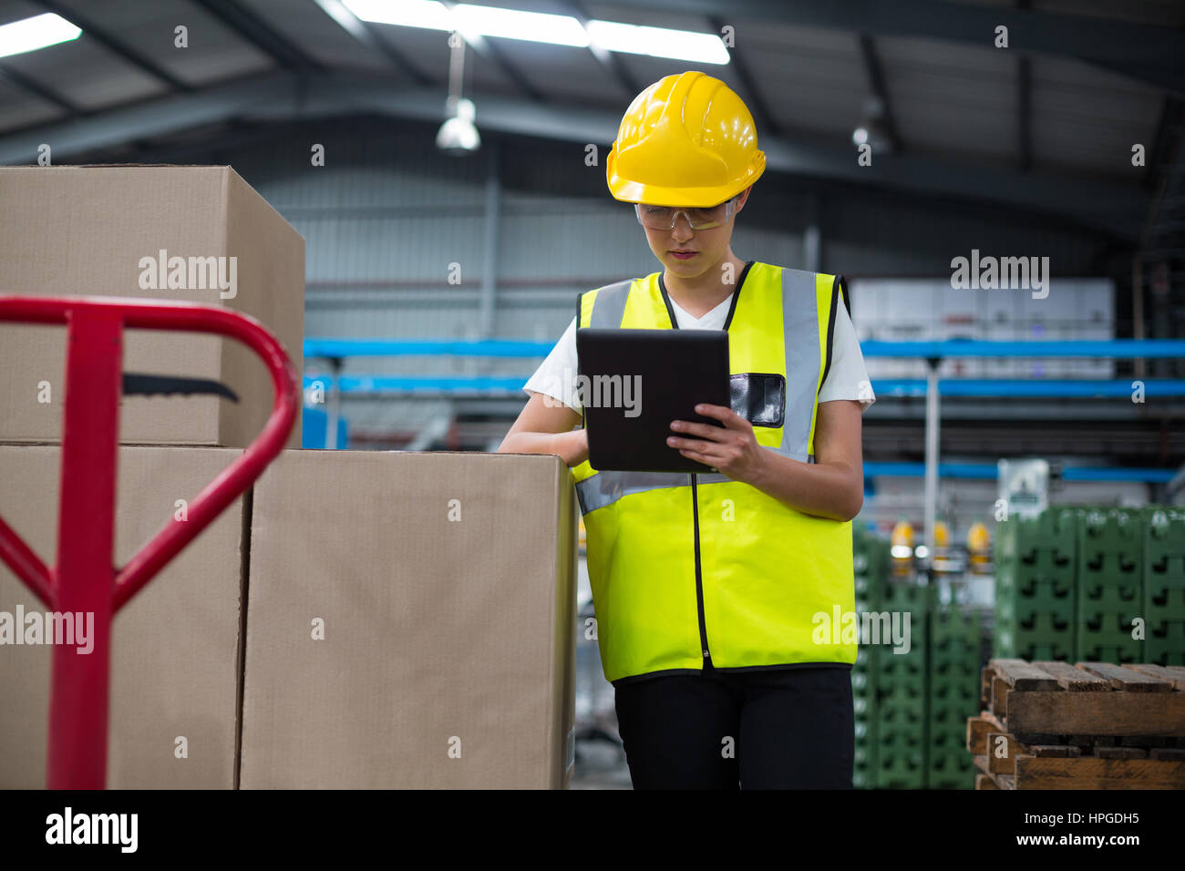 Attentive female factory worker using a digital tablet in factory Stock ...