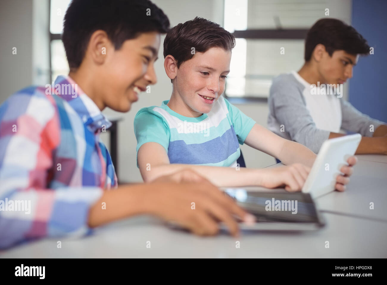 Students using digital tablet in classroom at school Stock Photo - Alamy