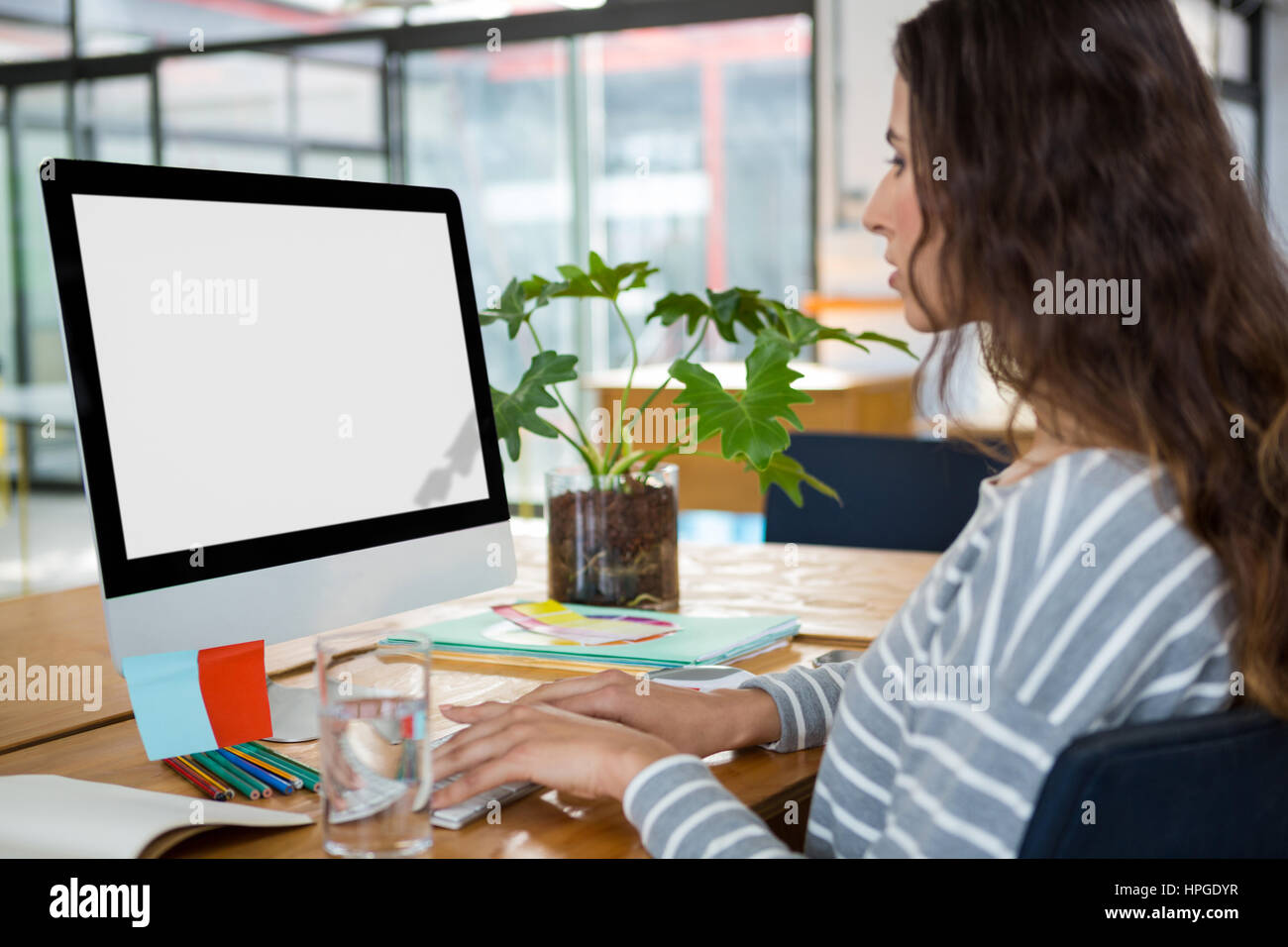 Female graphic designer working at desk in creative office Stock Photo ...