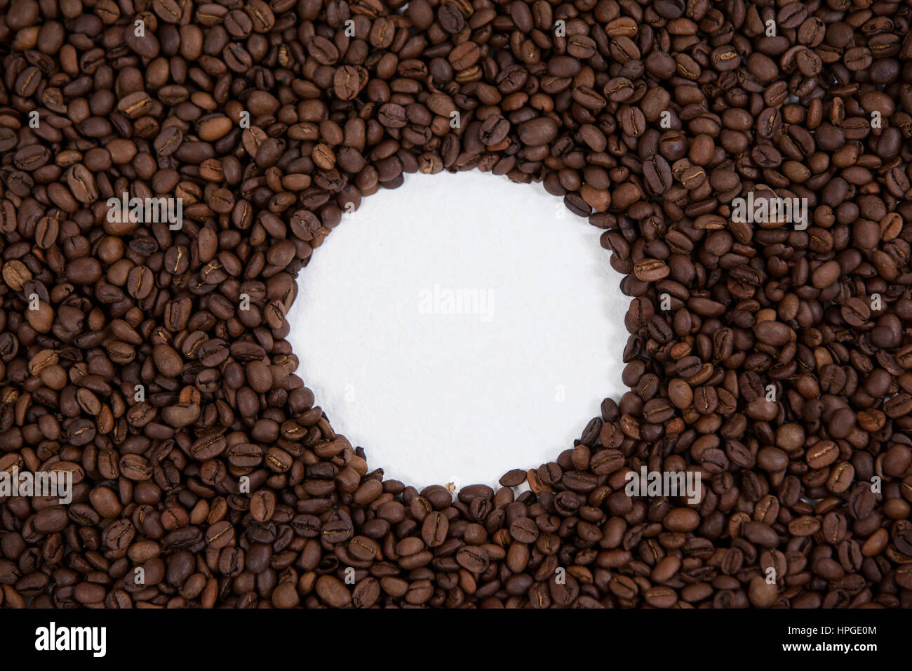 Coffee beans forming circle shape on white background Stock Photo - Alamy