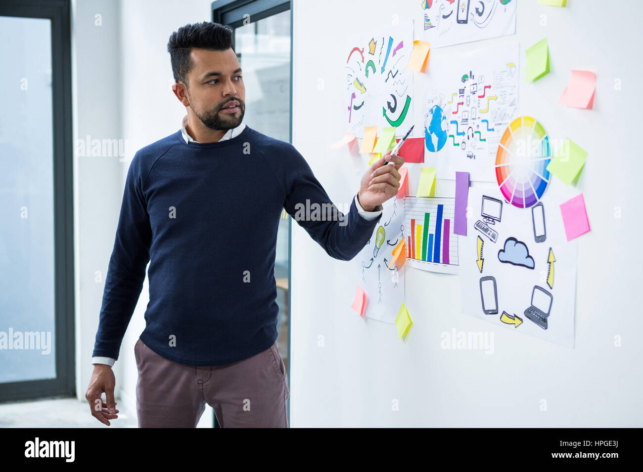Graphic designer giving presentation in creative office Stock Photo - Alamy