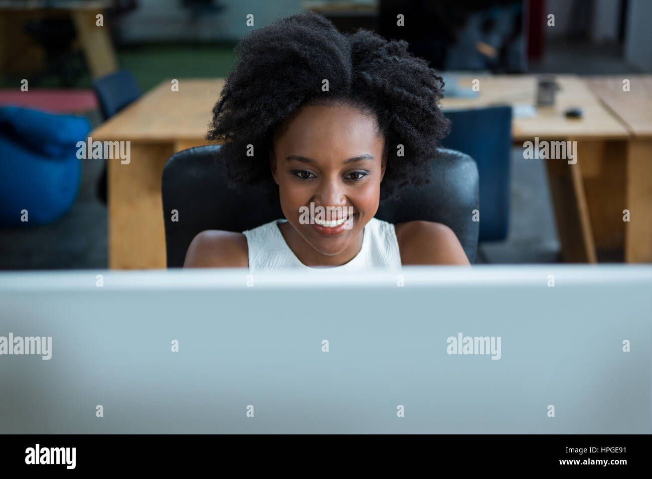 Female graphic designer using desktop pc in creative office Stock Photo ...