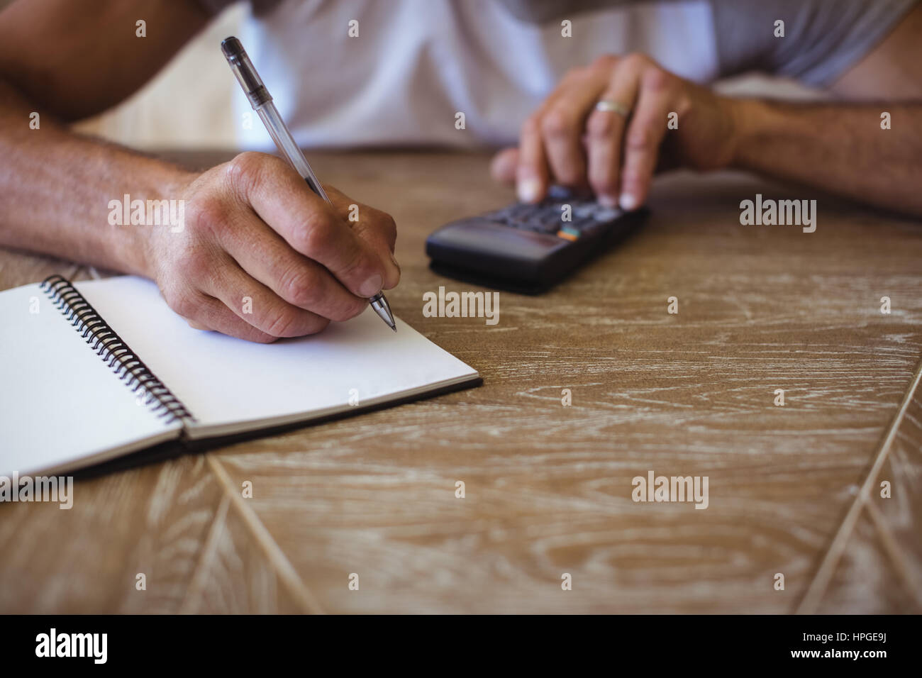 Man using calculator calculate hi-res stock photography and images - Alamy