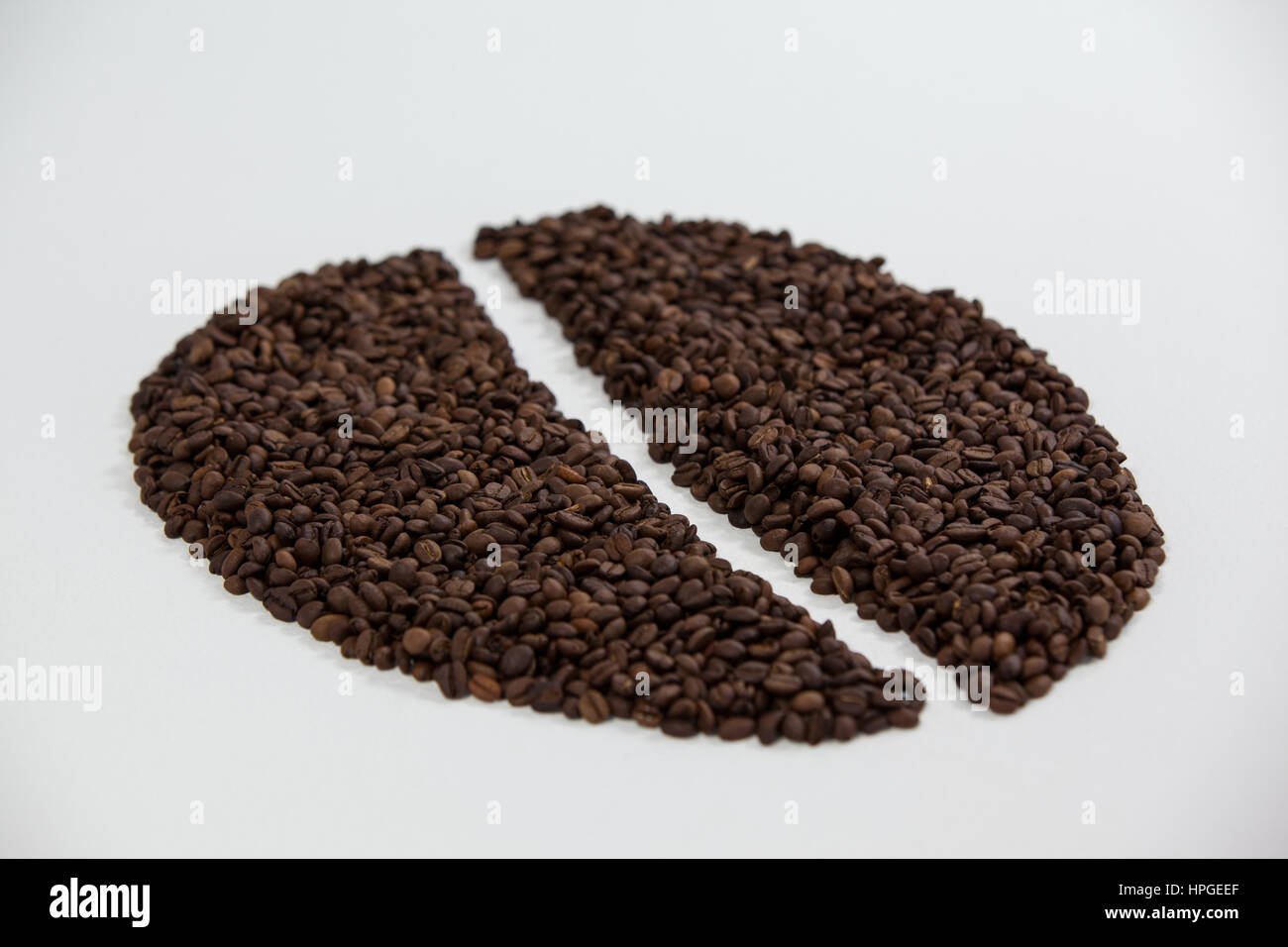 Coffee beans forming coffee bean shape on white background Stock Photo ...