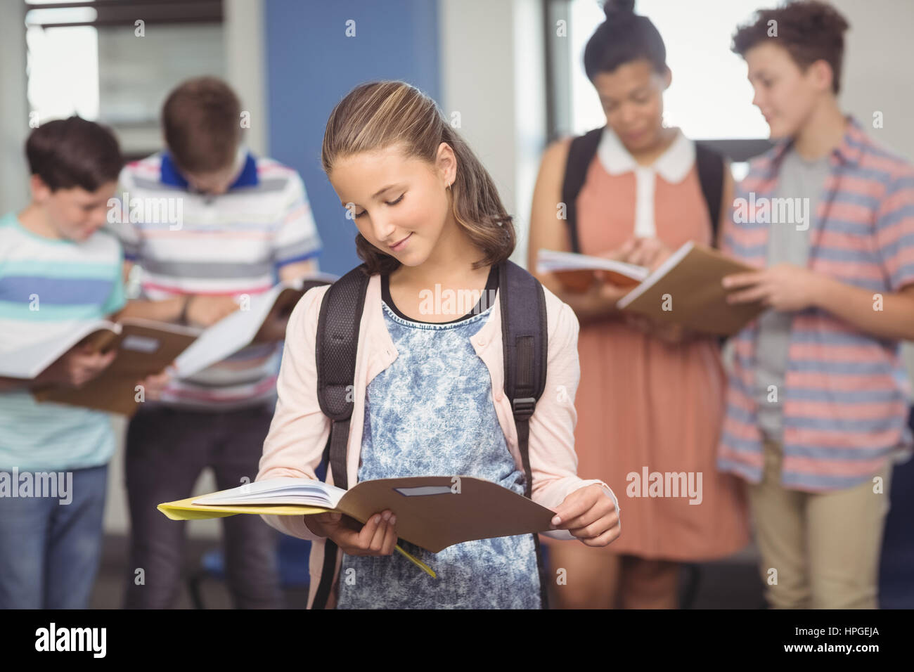 School girl reading book in classroom at school Stock Photo - Alamy