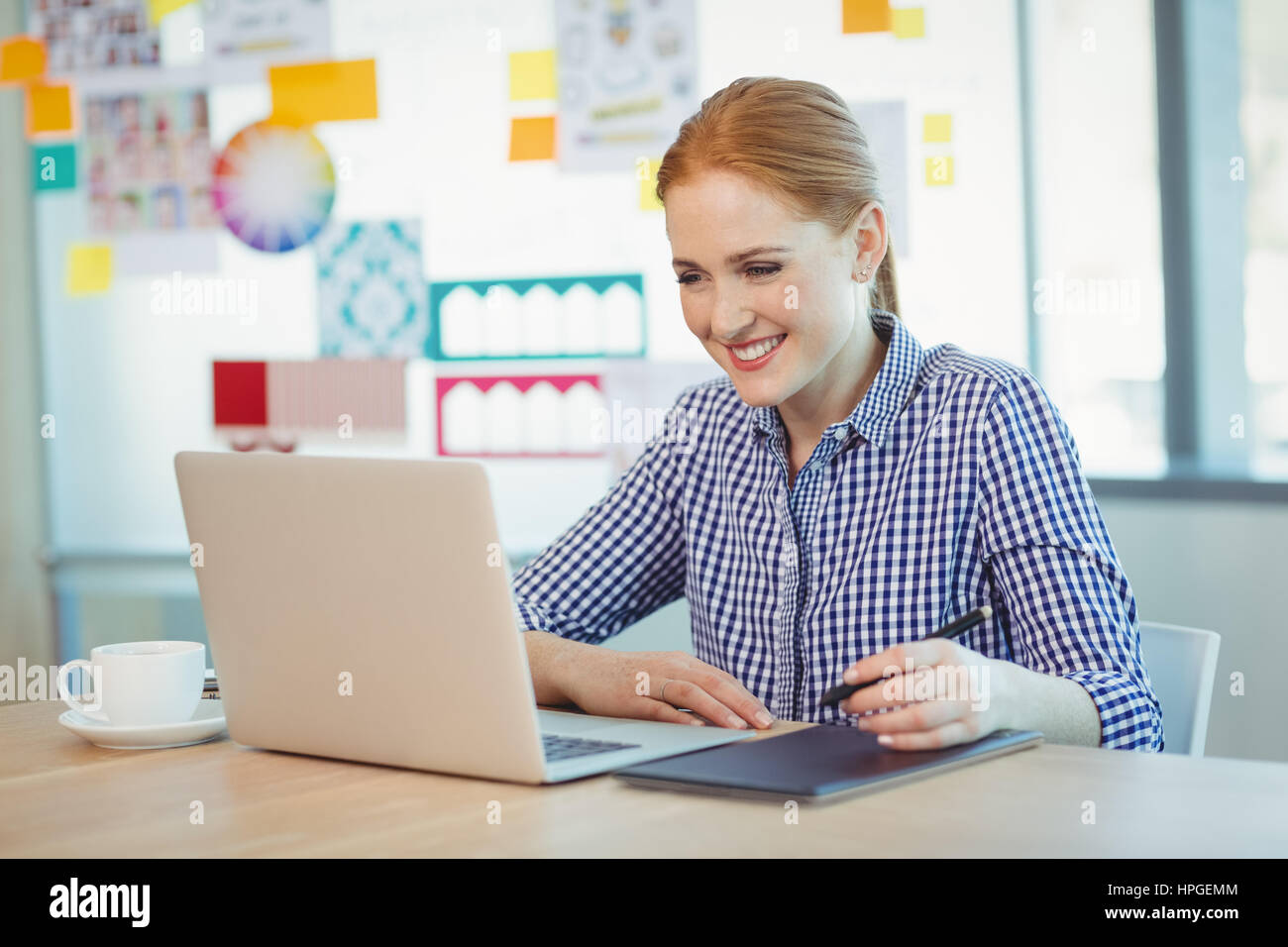 Female graphic designer using graphics tablet in office Stock Photo - Alamy