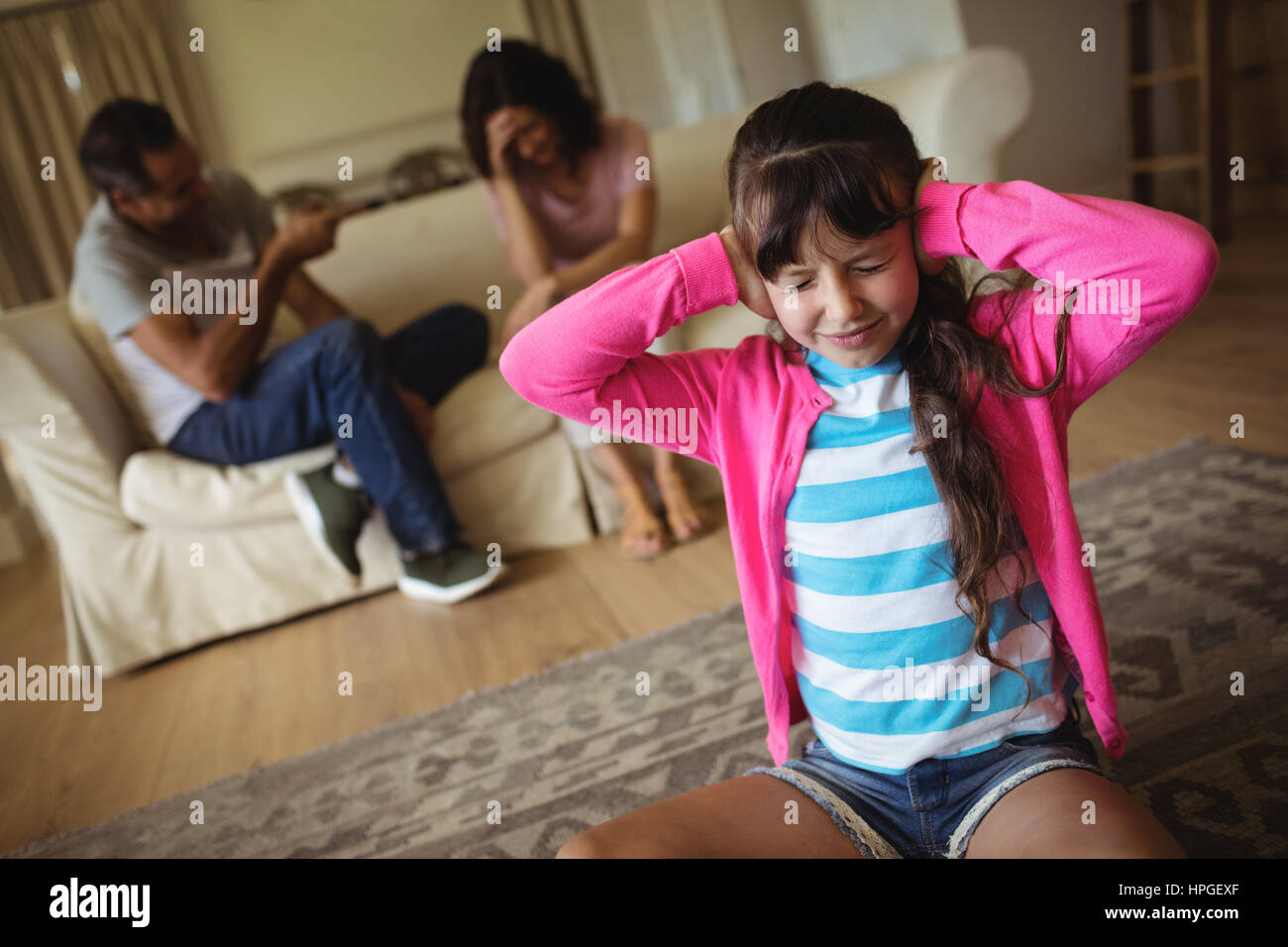 Sad girl fed up of her parents arguing at home Stock Photo - Alamy