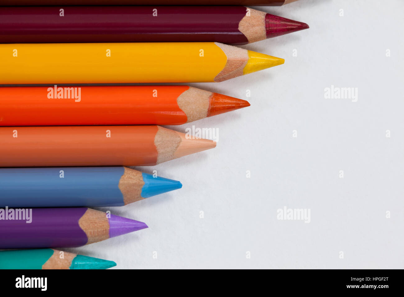 Colorful color pencil arranged in diagonal line on white background ...