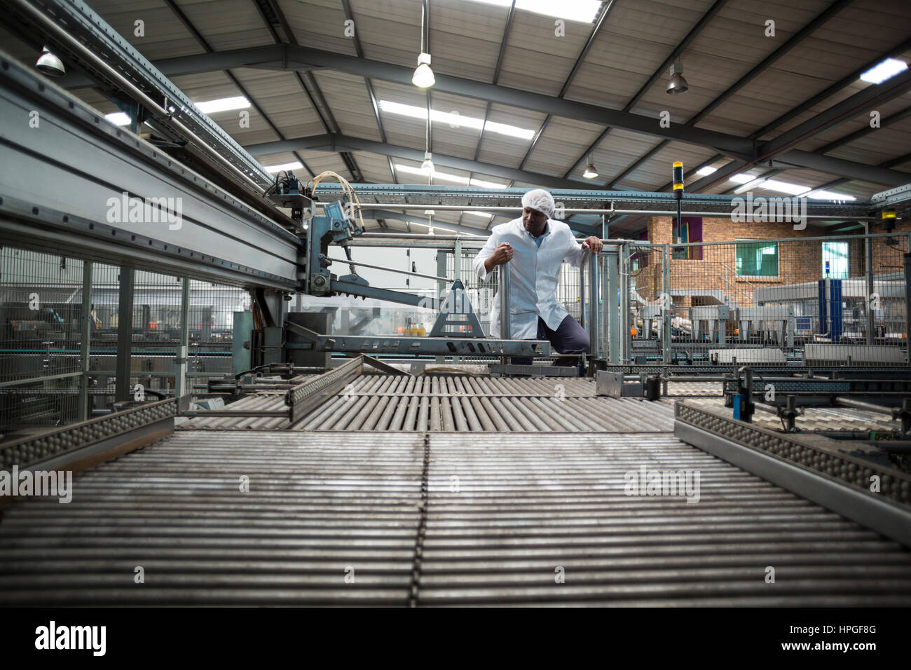 Factory engineer monitoring production line in drinks production plant ...