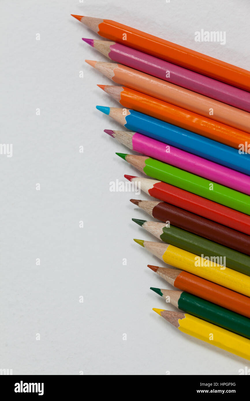 Colorful color pencil arranged in diagonal line on white background ...