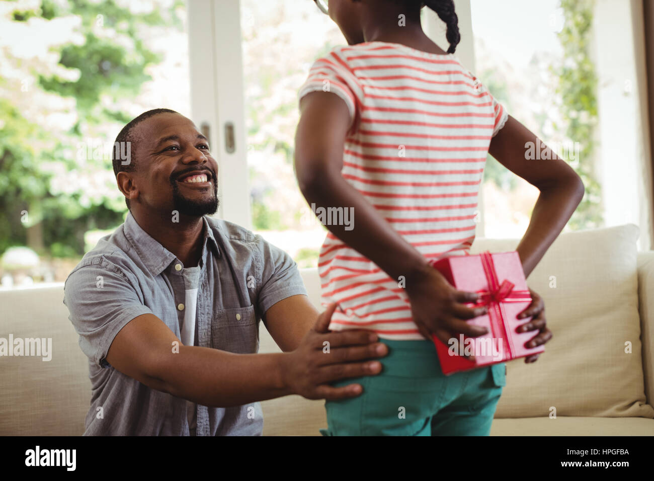 Girl child hiding behind man hi-res stock photography and images - Alamy