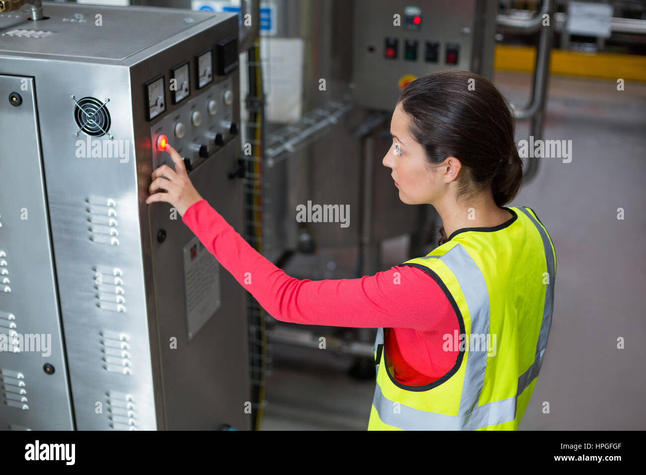 Woman factory worker operating machine hi-res stock photography and ...