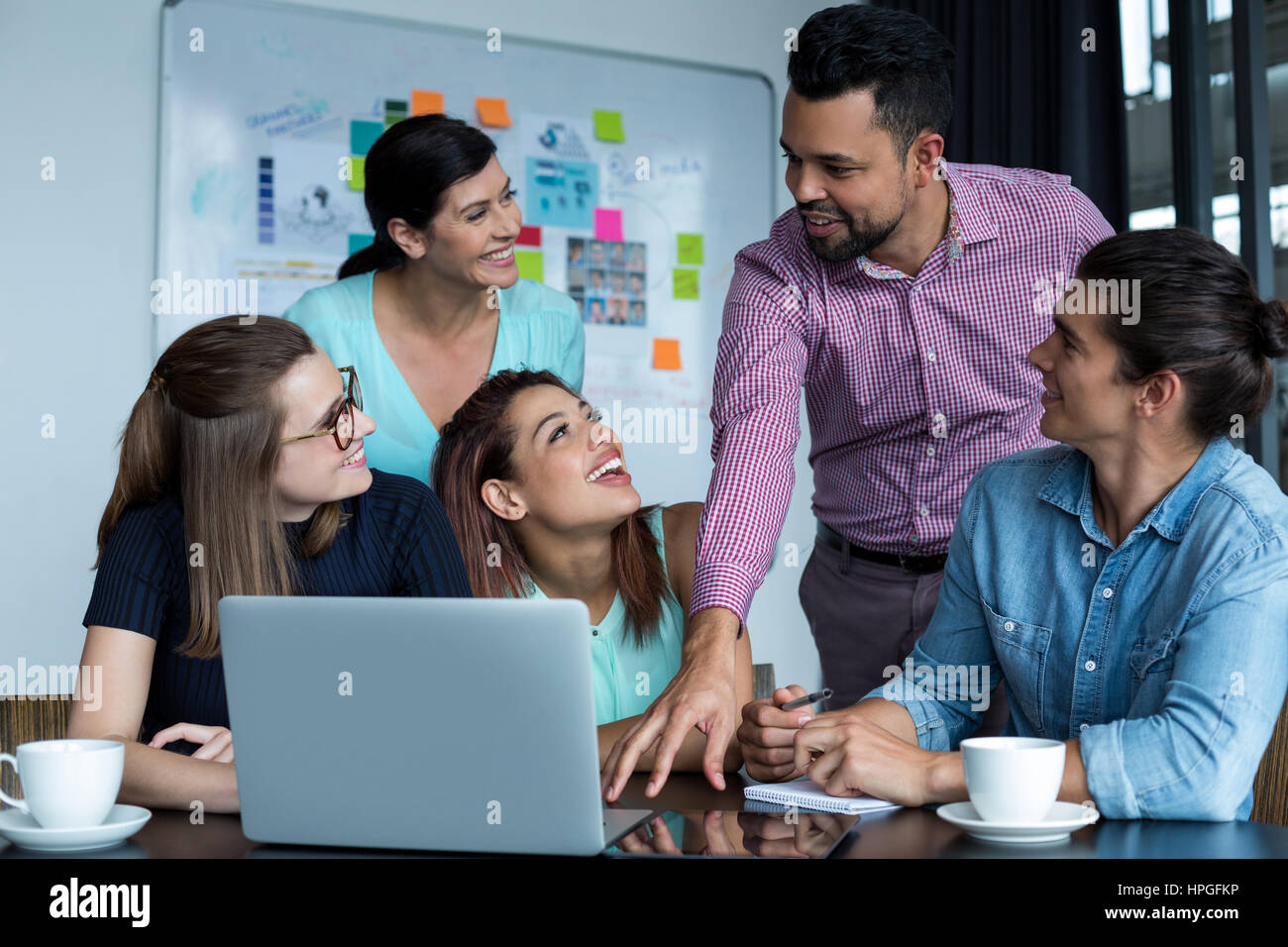 Smiling businesspeople having discussion during meeting in people Stock ...