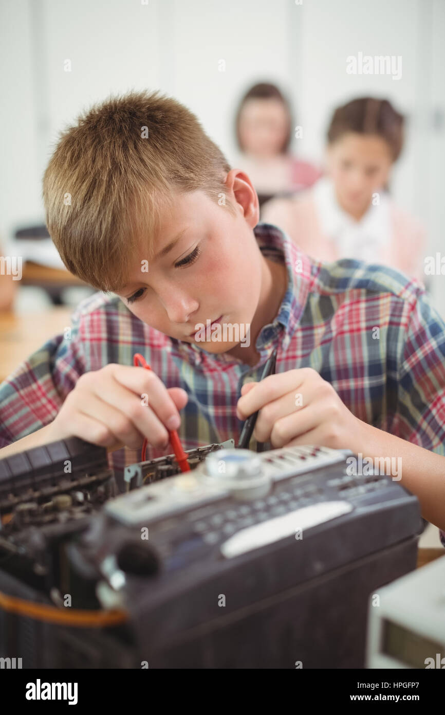 Schoolboy repairing a printer in the classroom at school Stock Photo ...
