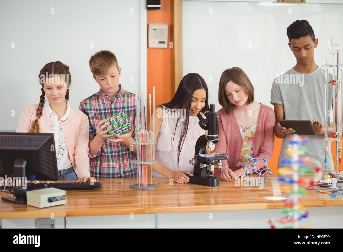 Group of students experimenting molecule model in laboratory at school ...