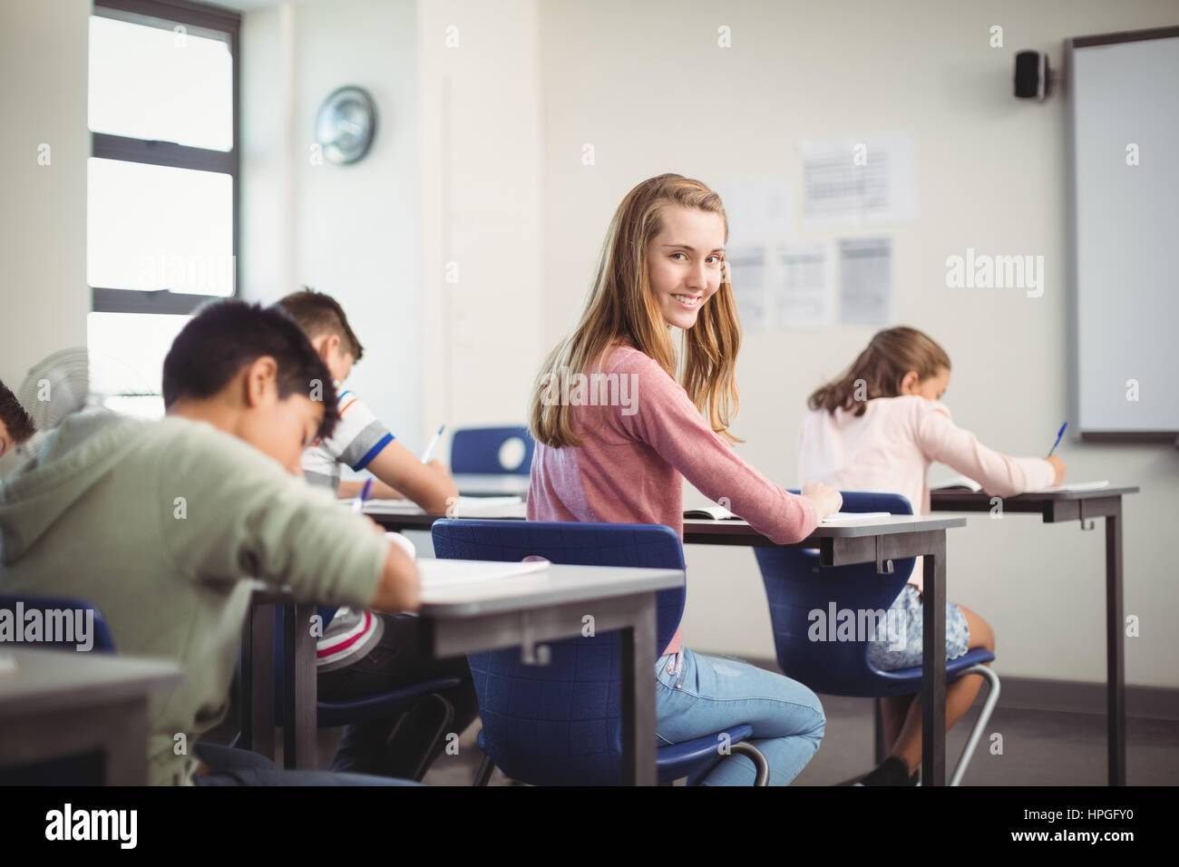 School kids doing homework in classroom at school Stock Photo - Alamy
