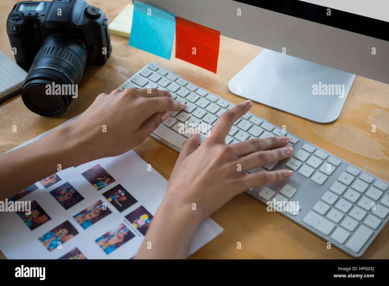 Hand of female graphic designer typing on keyboard in creative office ...