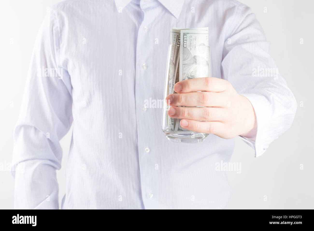 Businessman with money cocktail and cash in the glass Stock Photo - Alamy