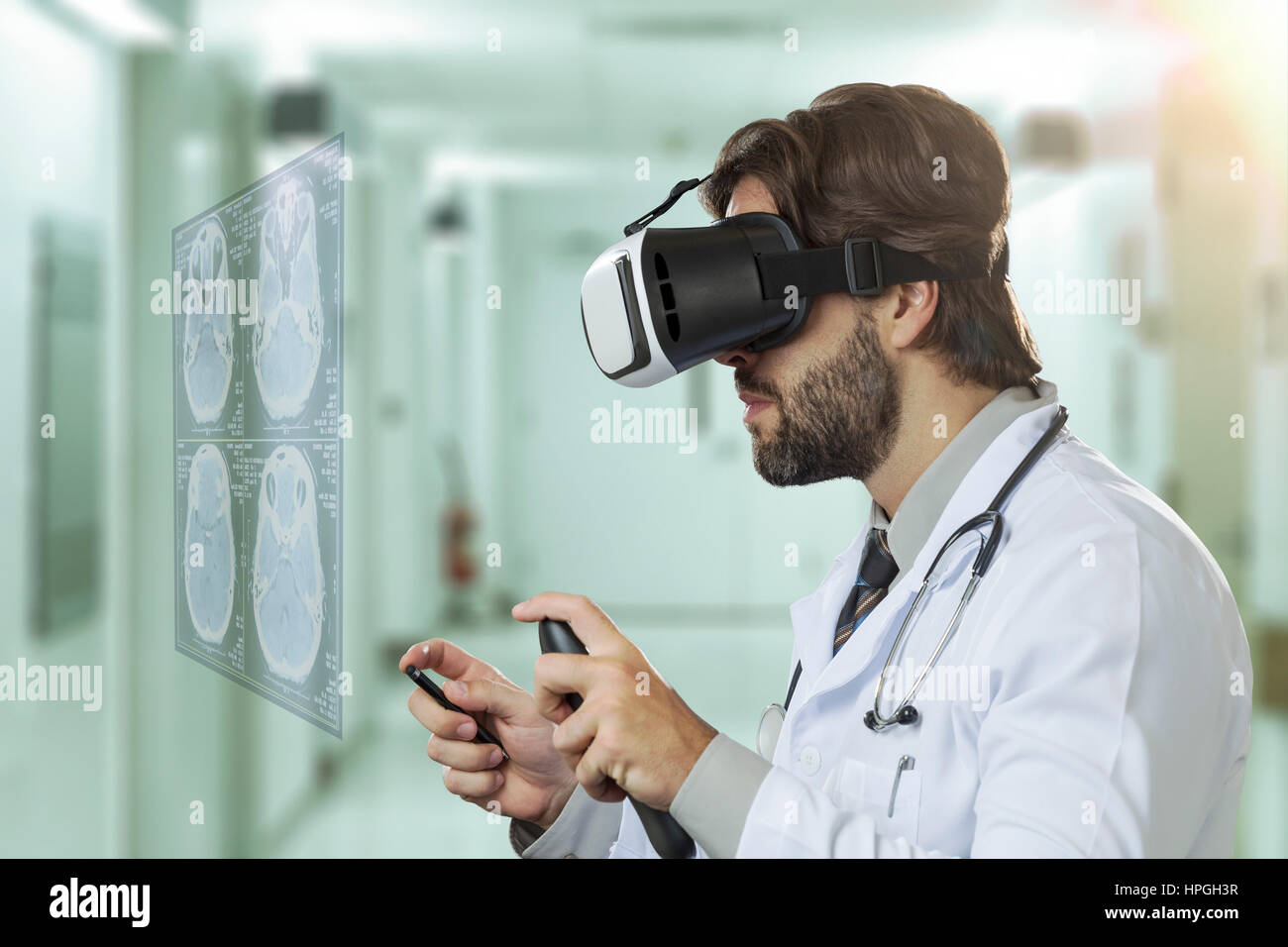 Male doctor at a hospital, using a Virtual Reality Glasses, looking at ...