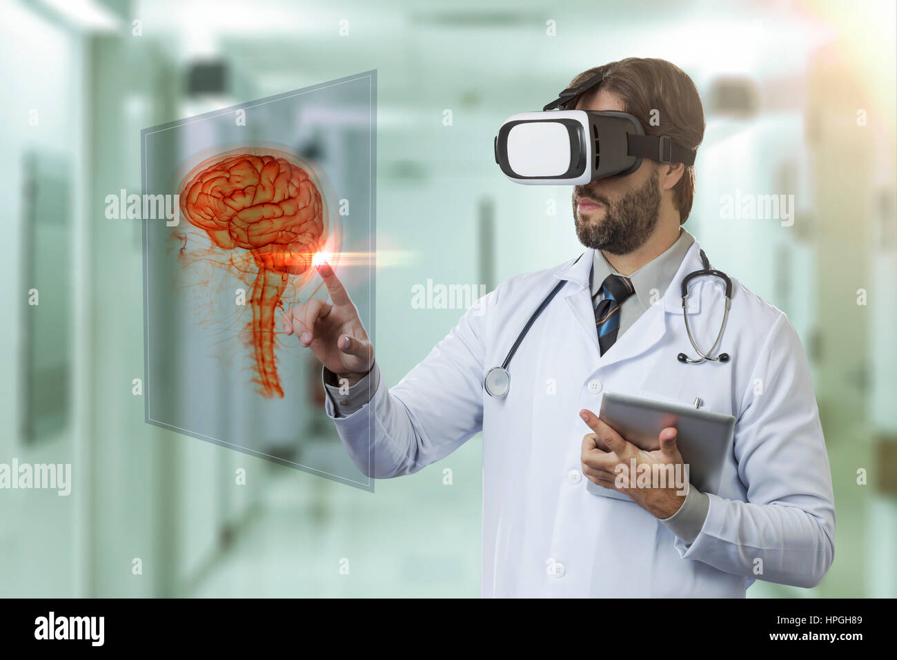 Doctor using tablet looking brain hi-res stock photography and images ...