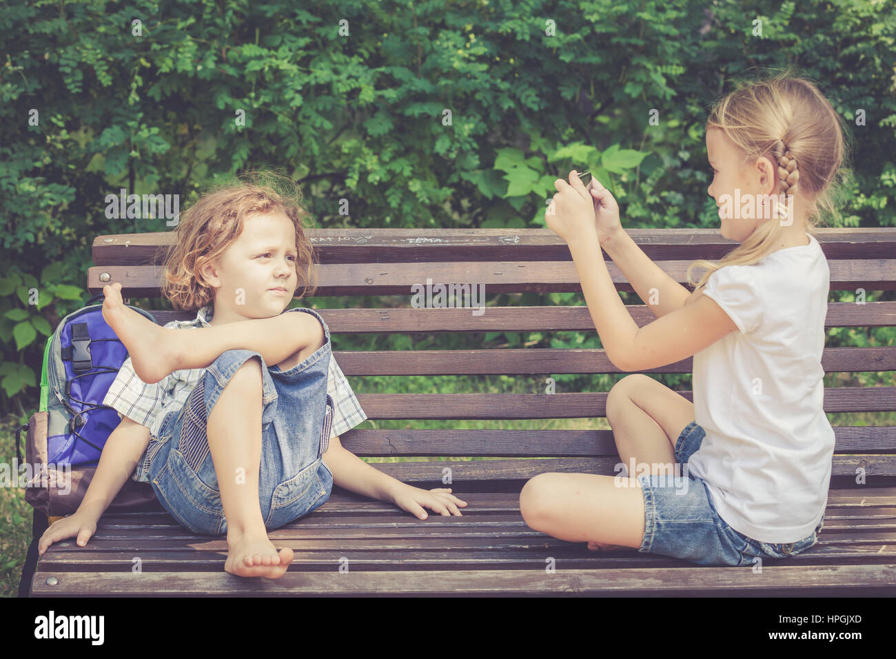 Two happy children playing in the park at the day time. Concept Brother ...