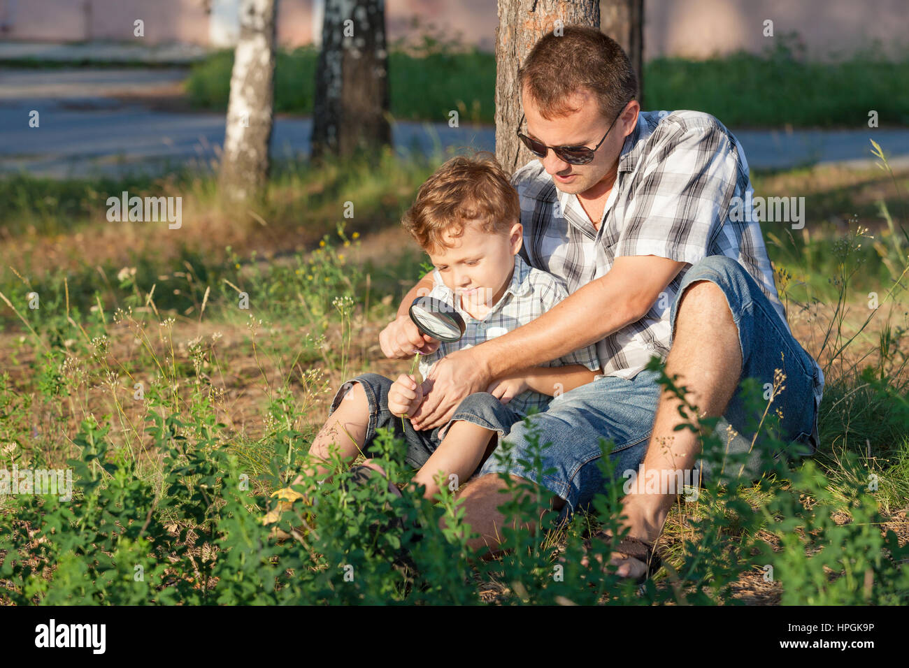 Father and son playing in the park at the day time. Concept of friendly ...