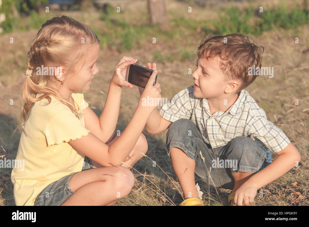 Two happy children playing in park at the day time Stock Photo - Alamy