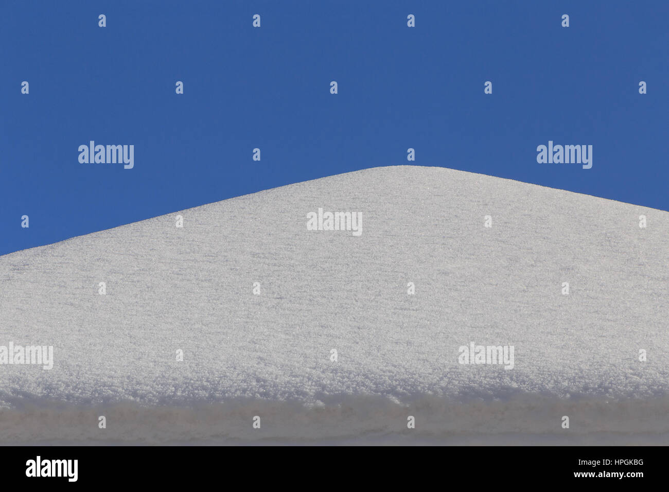 heap of snow on roof over blue sky Stock Photo - Alamy