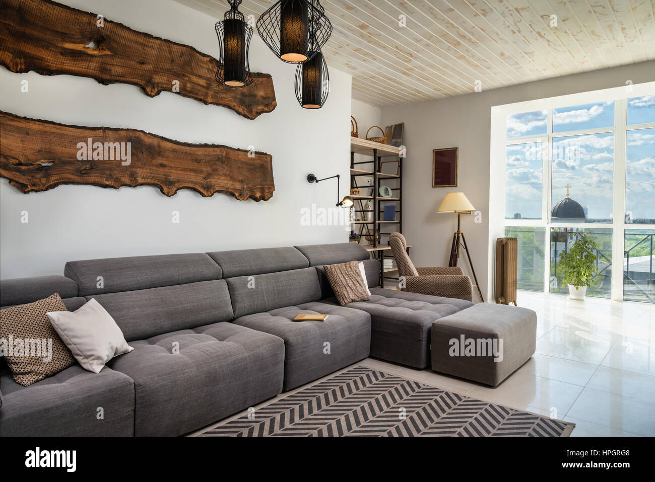 Comfortable living room with panoramic window Stock Photo - Alamy