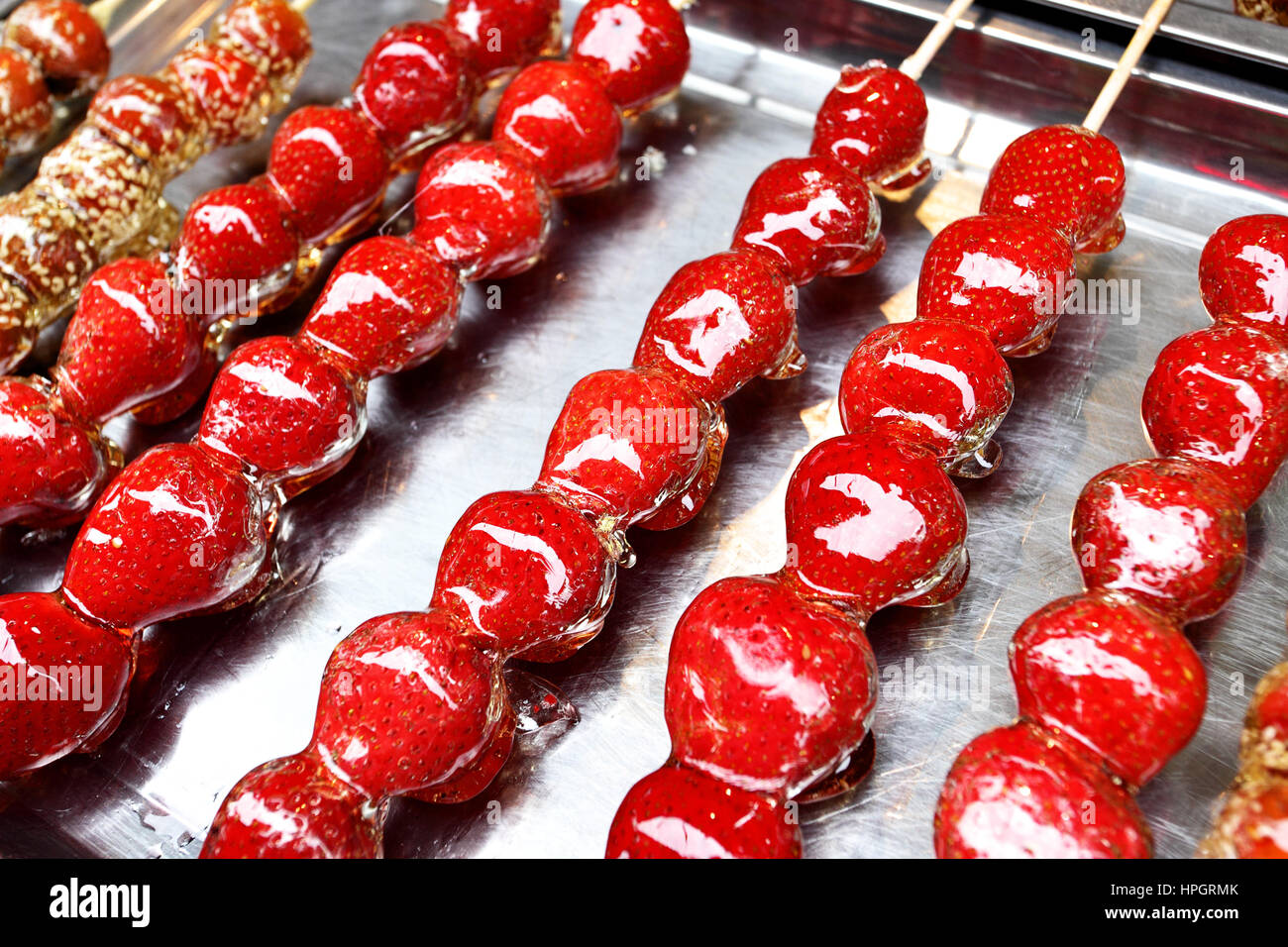 Tray with candied strawberry in Shanghai, China Stock Photo - Alamy